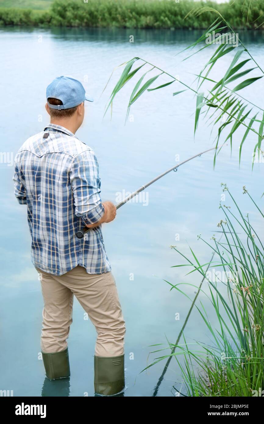 Man fishing on riverside hi-res stock photography and images - Alamy