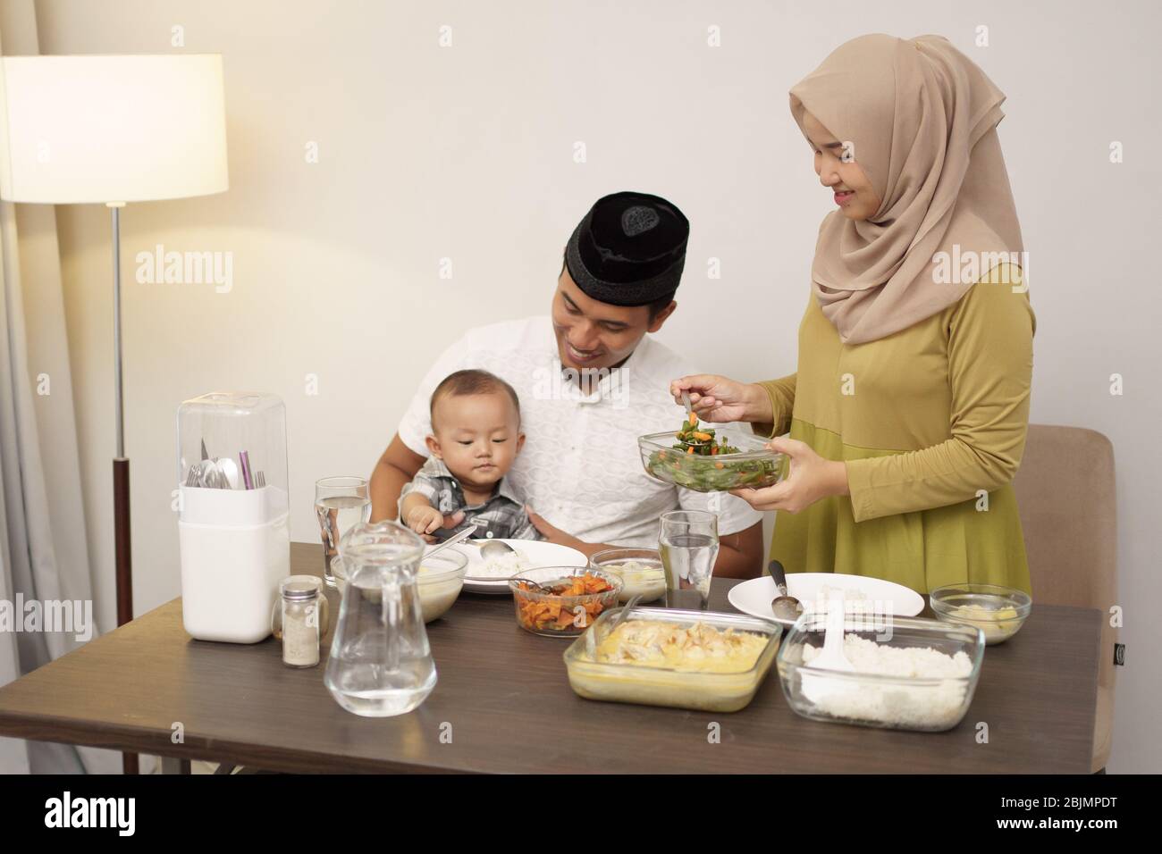 muslim family with toddler breakfasting during ramadan kareem at home ...