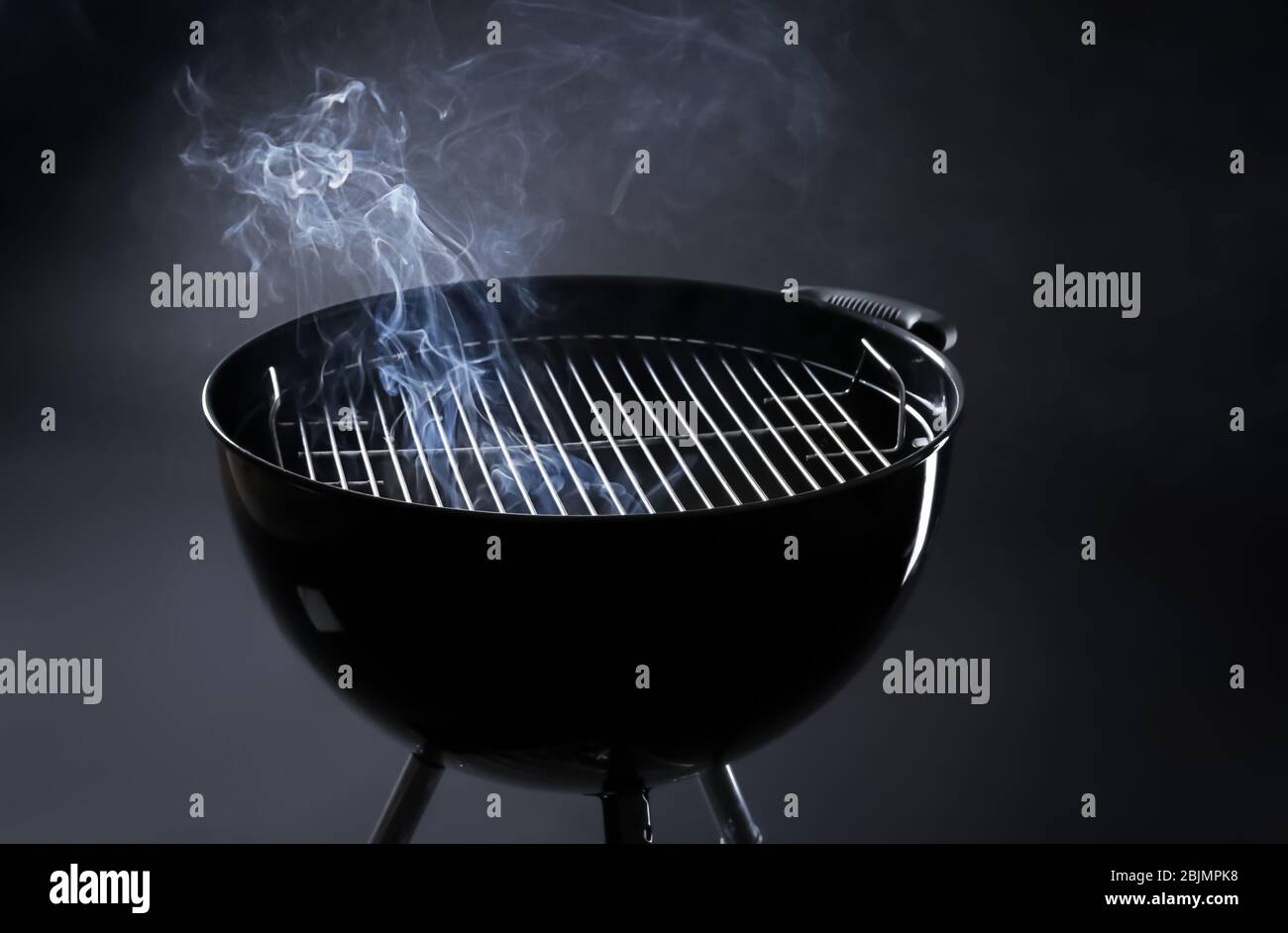 Barbecue grill on dark background Stock Photo - Alamy
