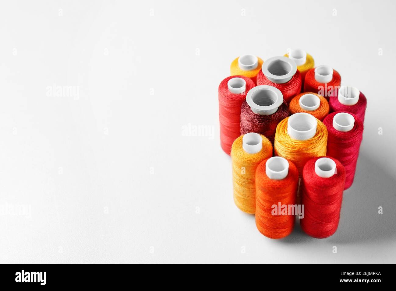 Red and orange threads of different shades on white background Stock ...