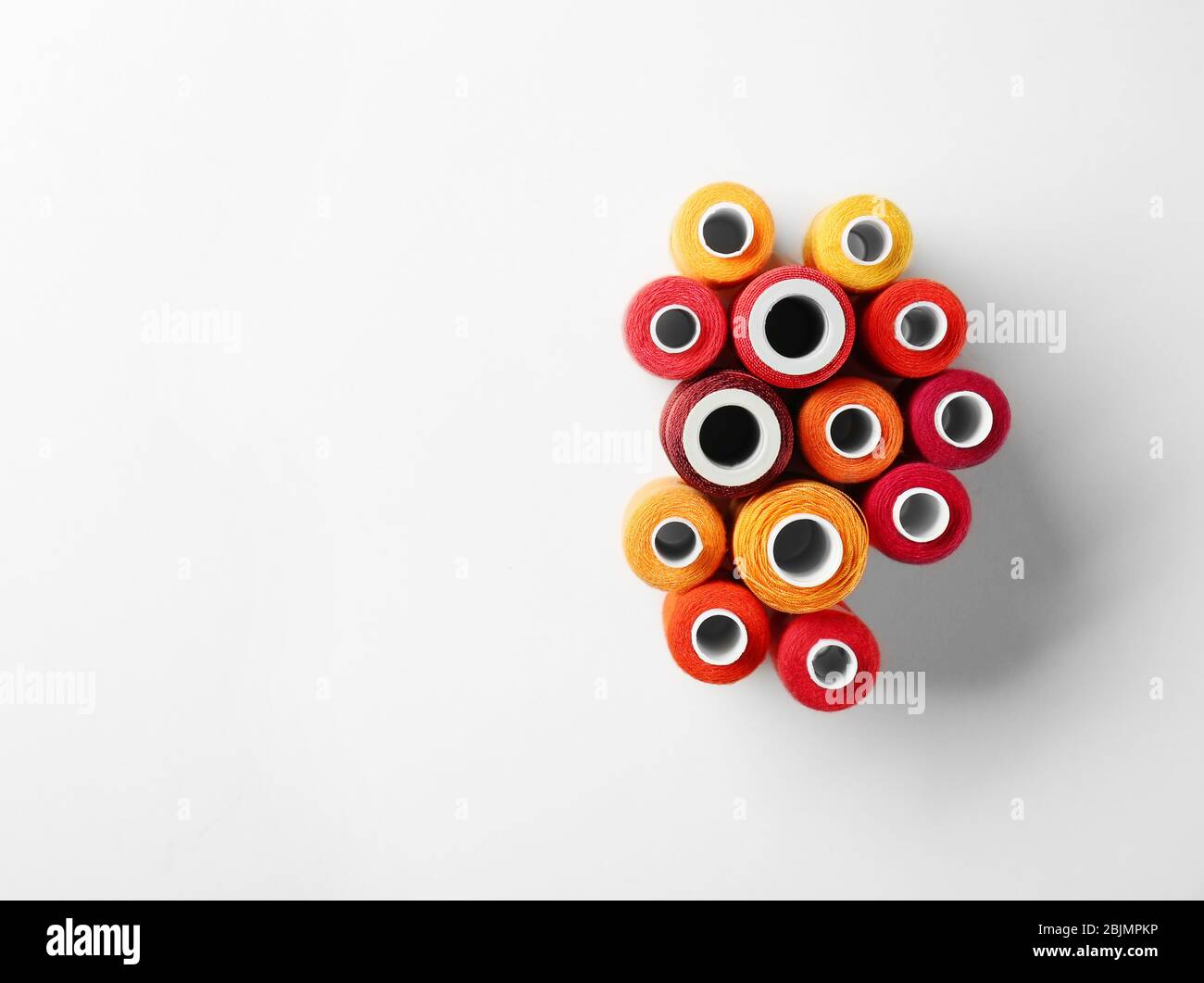 Red and orange threads of different shades on white background Stock ...