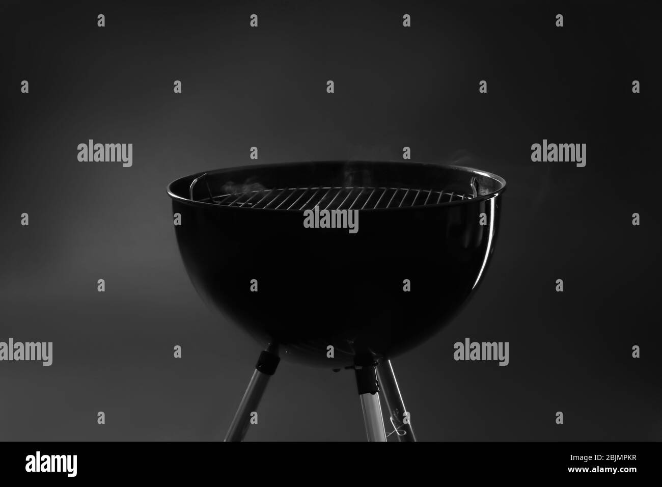 Barbecue grill on dark background Stock Photo - Alamy