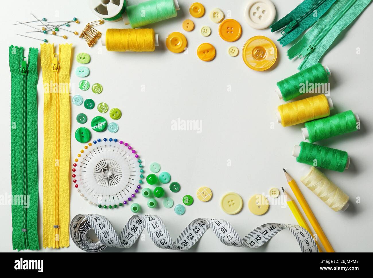 Composition with threads and sewing accessories on white background ...