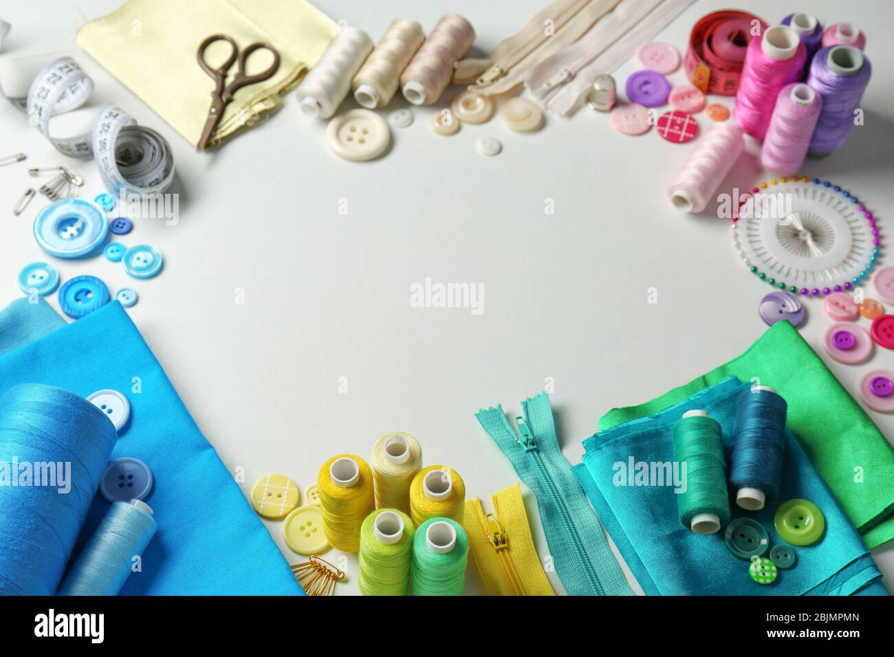 Composition with threads and sewing accessories on white background ...