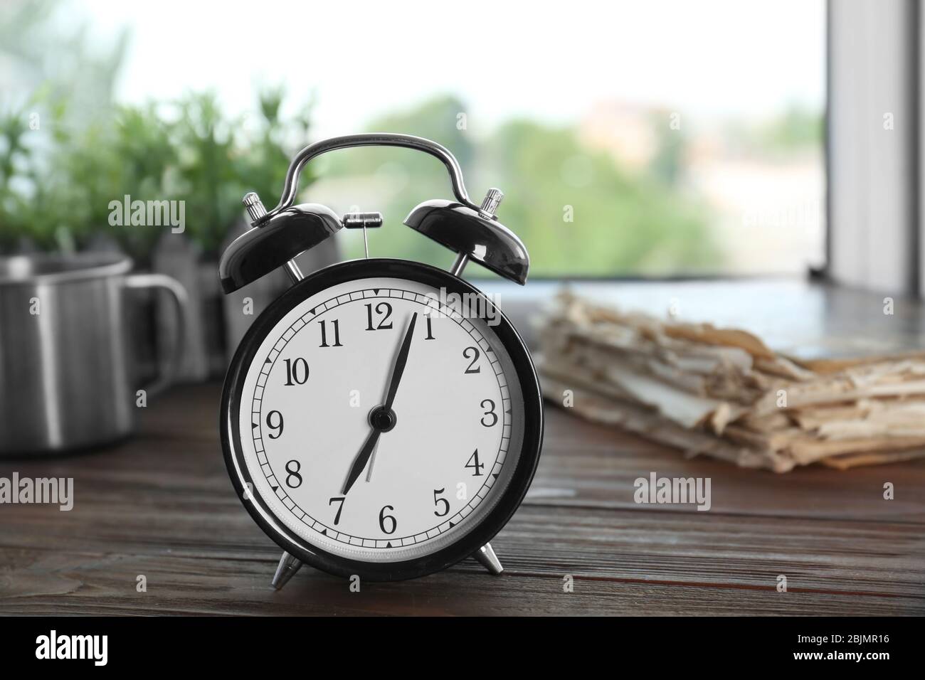 Alarm clock on wooden window sill. Morning routine concept Stock Photo ...