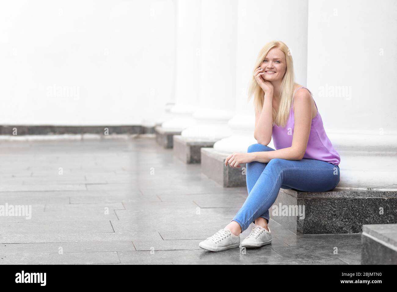 Sitting by column hi-res stock photography and images - Alamy