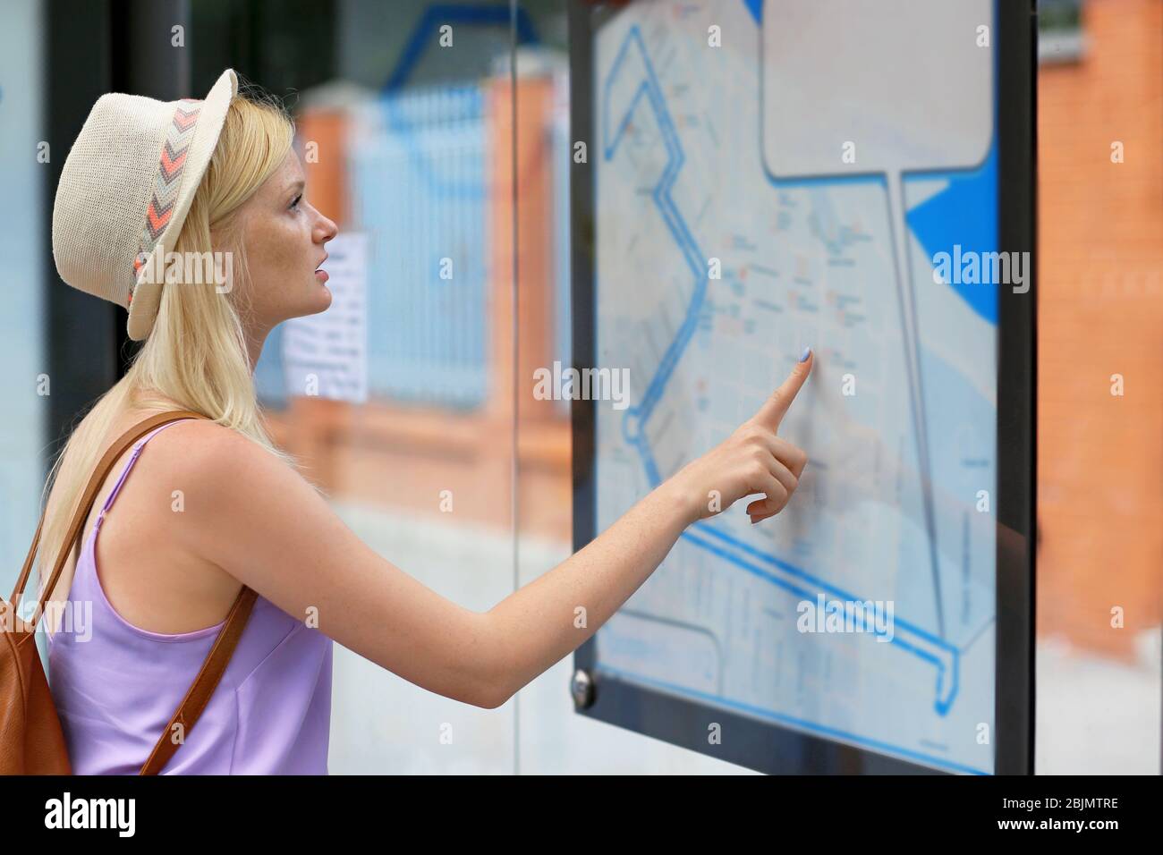 Female tourist looking at map of city transport routes outdoors Stock ...