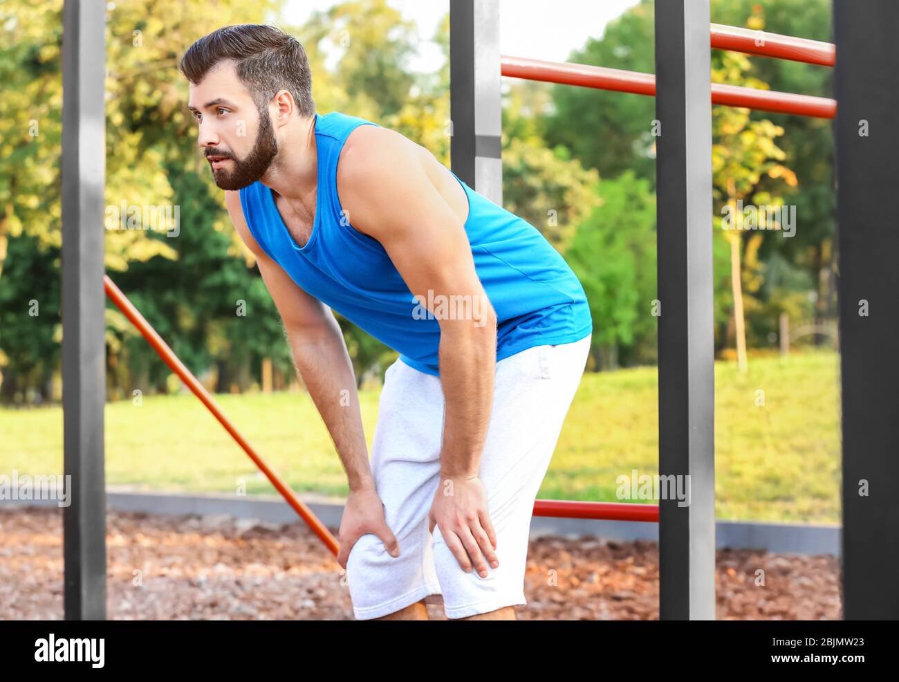 Handsome young man taking rest after training outdoors Stock Photo - Alamy