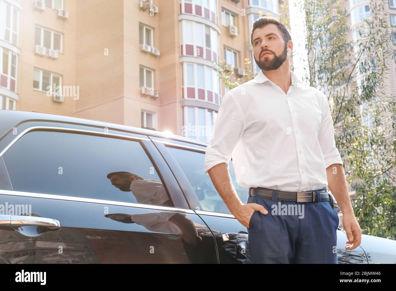 Man standing near white car hi-res stock photography and images - Alamy