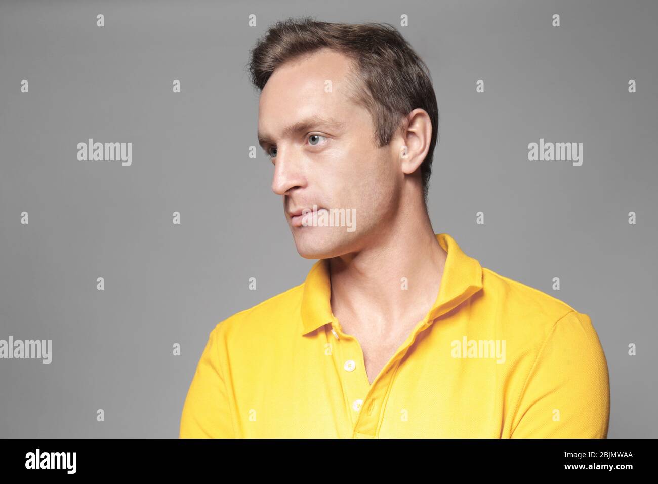 Handsome man on grey background Stock Photo - Alamy