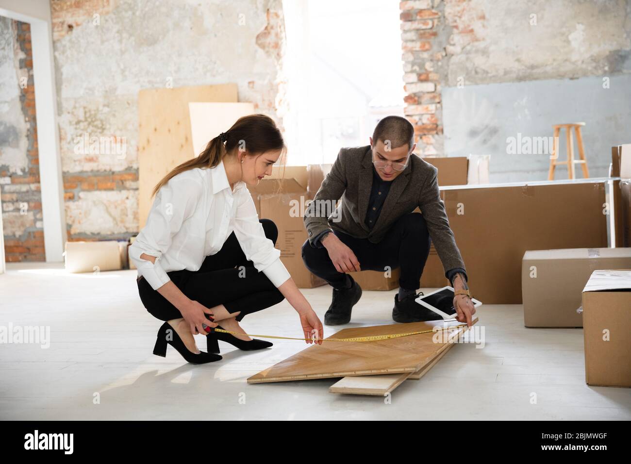 Repairs details. Female estate agent showing new home to a young man ...