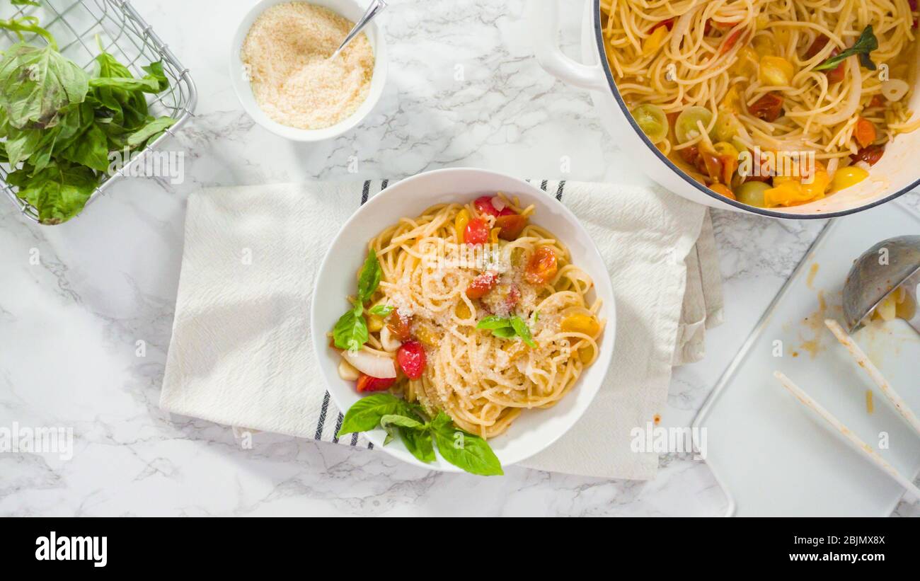 Flat lay. Step by step. Serving a one-pot pasta into a white pasta ...
