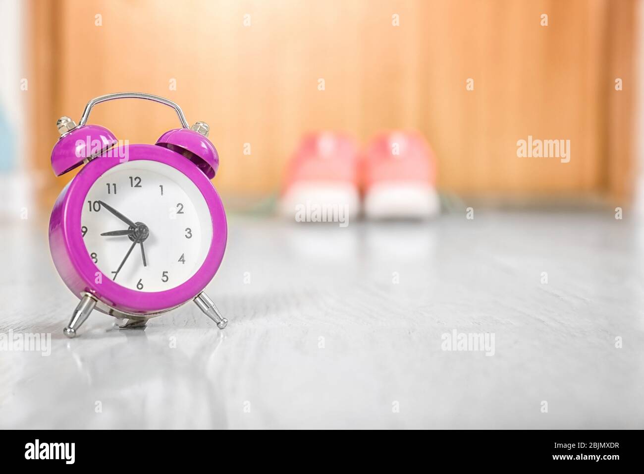 Alarm clock on floor indoors. Morning routine concept Stock Photo - Alamy