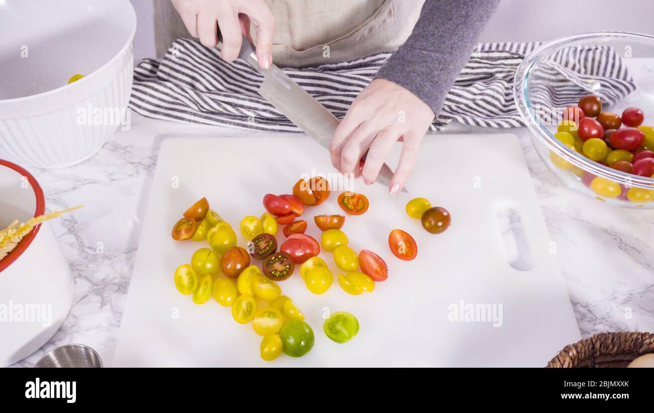 Step by step. Cutting vegetables on a white cutting board to make a one ...
