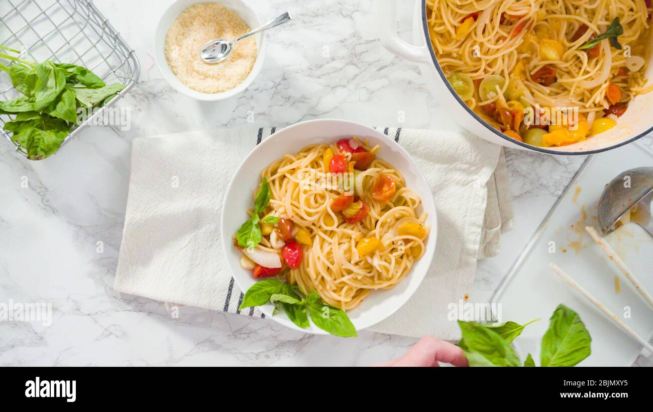 Flat lay. Step by step. Serving a one-pot pasta into a white pasta ...
