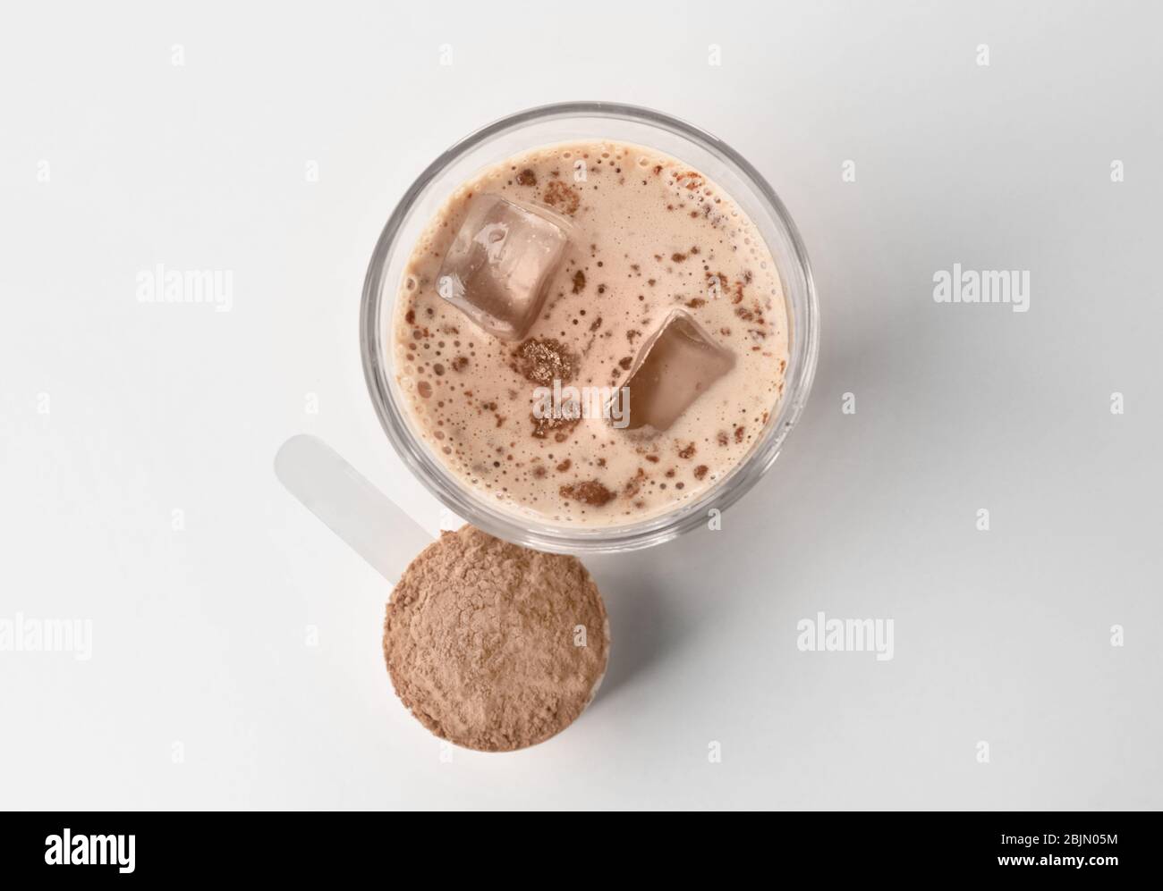 Glass with protein shake and powder in scoop on white background Stock ...