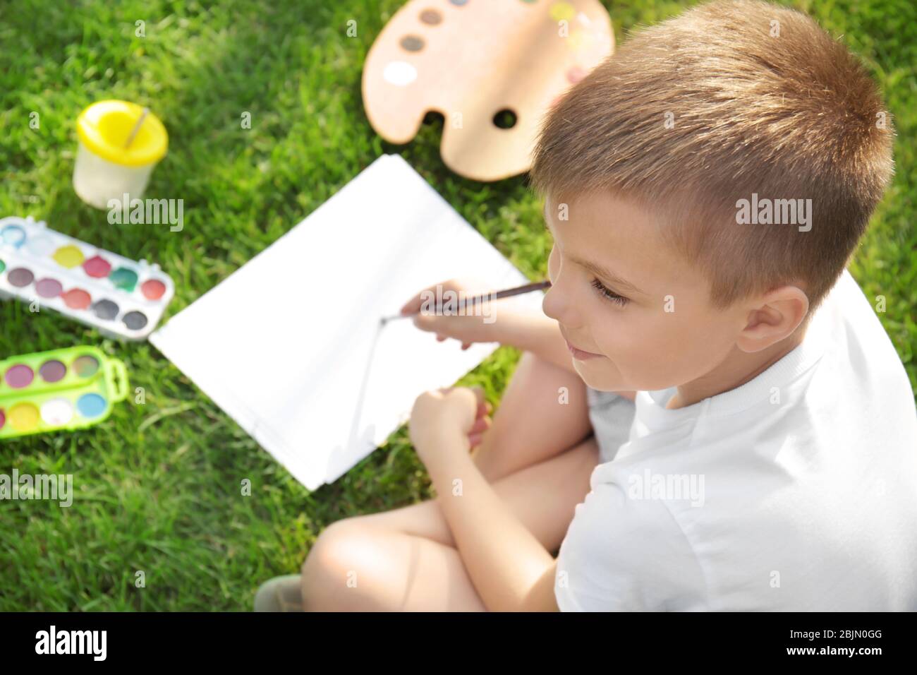 Cute little boy painting picture, outdoors Stock Photo - Alamy