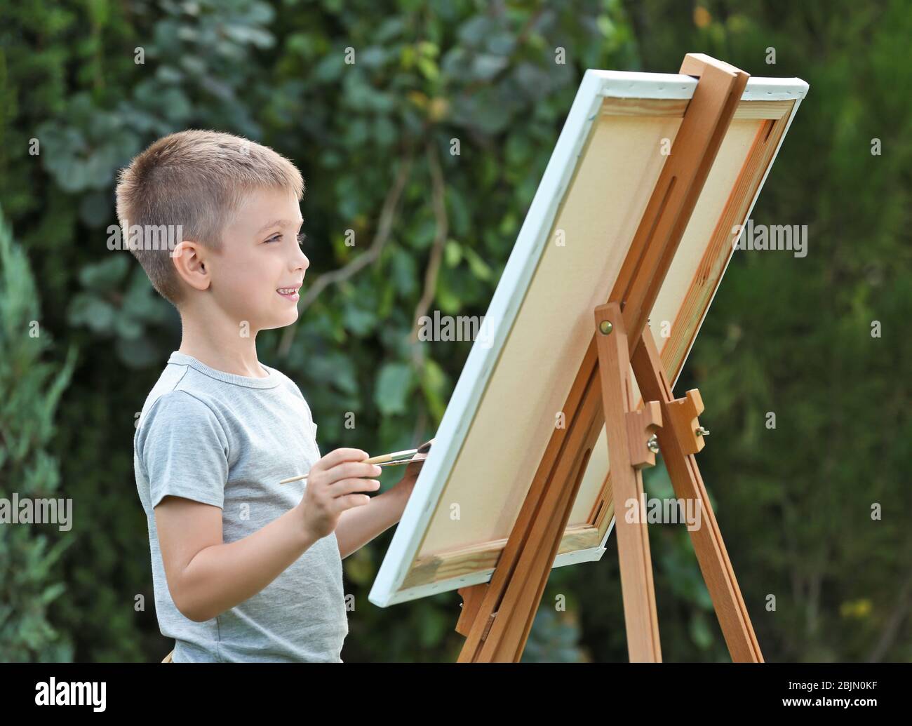 Cute little boy painting picture, outdoors Stock Photo - Alamy