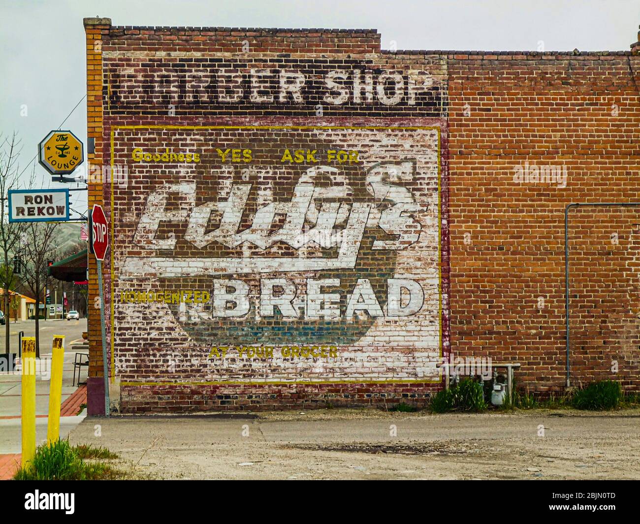 Faded signs painted on an old bick wall in Emmett, Idaho. Barber Shop ...