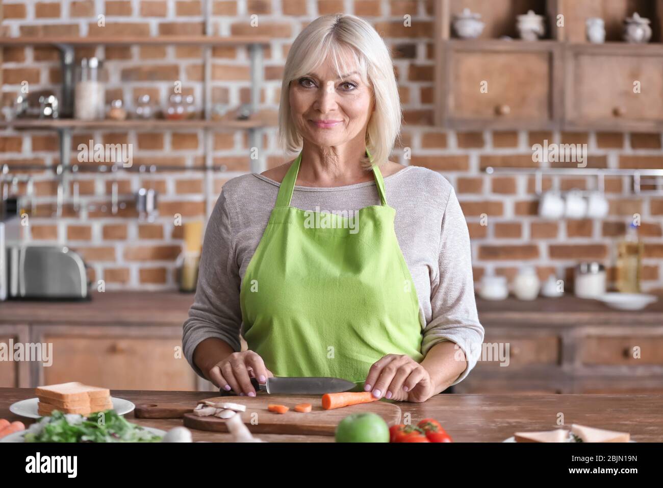 Mature woman cooking hi-res stock photography and images - Alamy