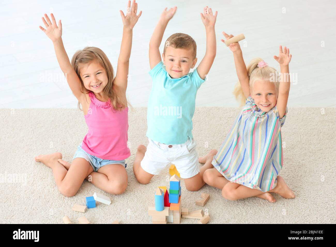 Cute children playing with blocks indoor Stock Photo - Alamy