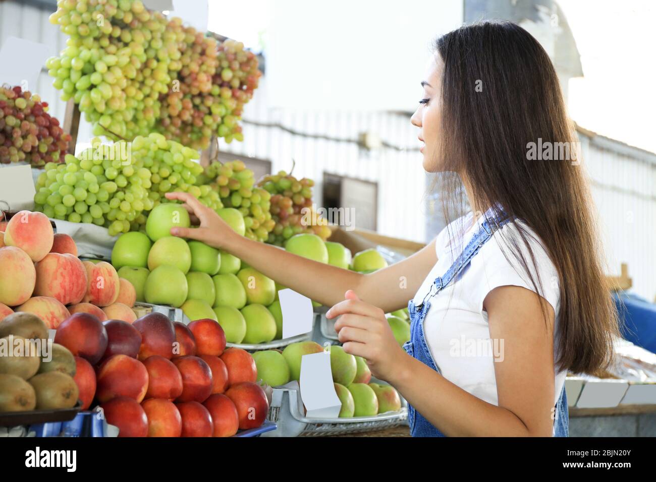 Woman choosing fruits hi-res stock photography and images - Alamy