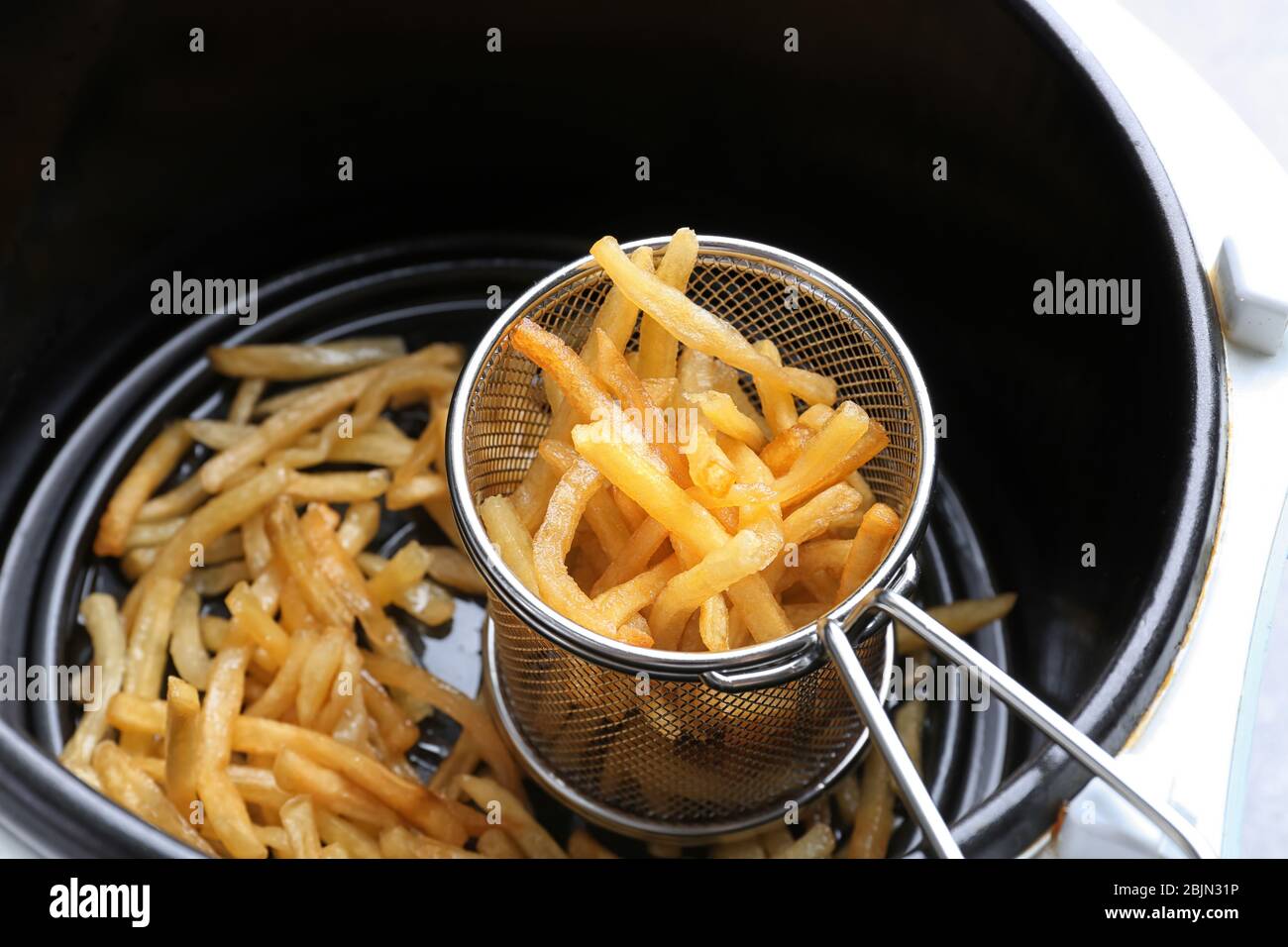 Cooking yummy french fries in chip fryer Stock Photo - Alamy