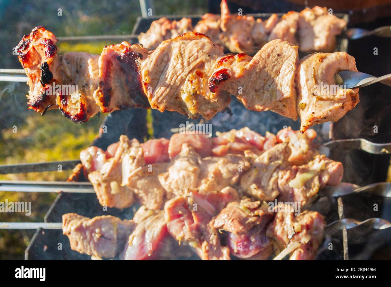 Fresh pork shish kebab is fried on skewers on the grill Stock Photo - Alamy