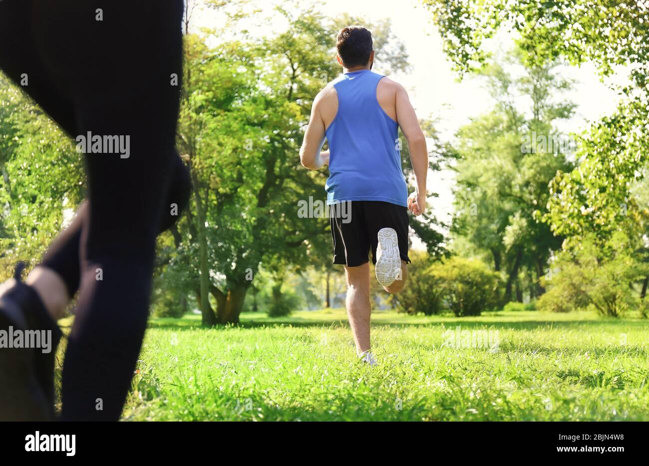 Young people running in park hi-res stock photography and images - Alamy