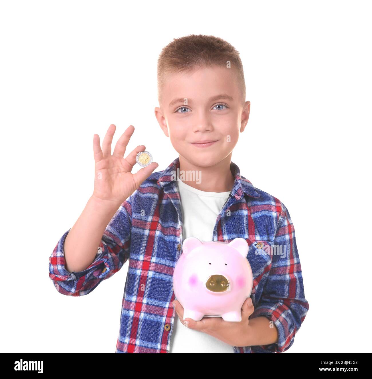 Cute little boy with coin and piggy bank on white background Stock ...