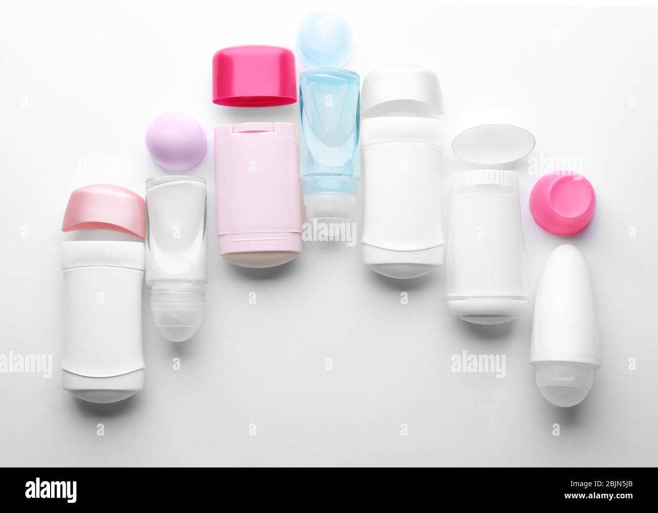 Various deodorants for women on white background Stock Photo - Alamy