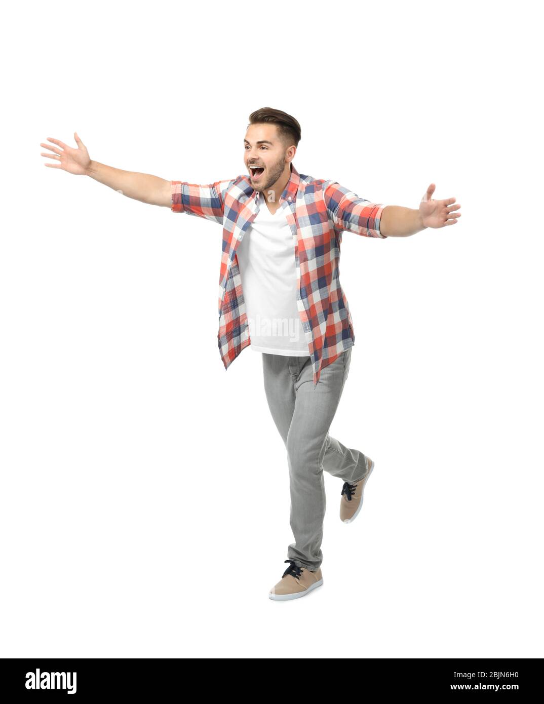 Young man in casual clothes running against white background Stock ...