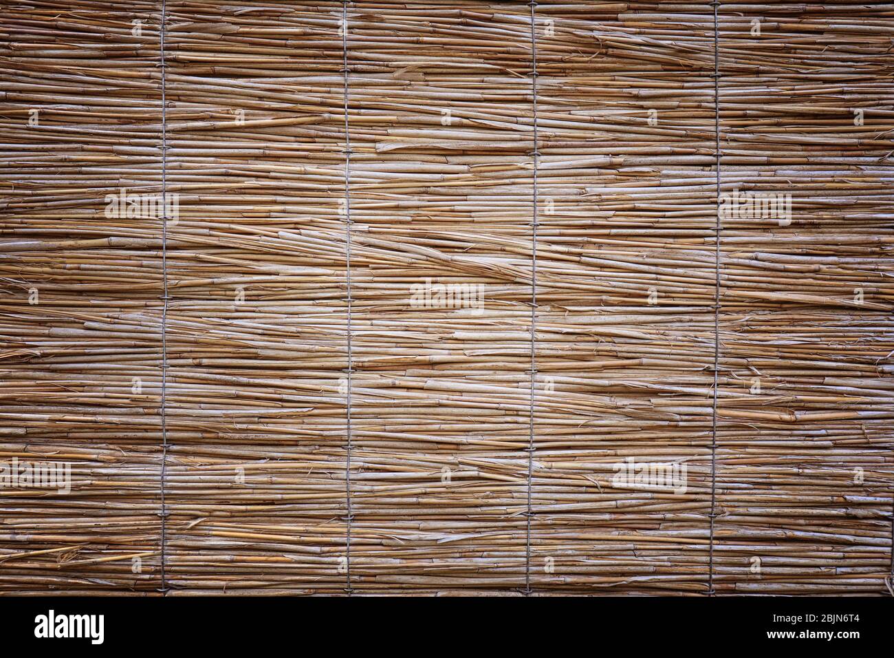 Straw fence as background Stock Photo - Alamy