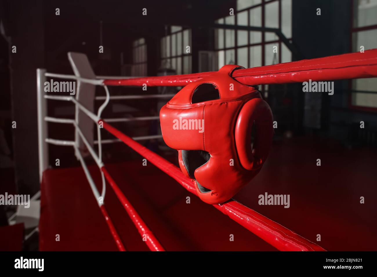 Headgear on ropes of boxing ring in gym Stock Photo - Alamy