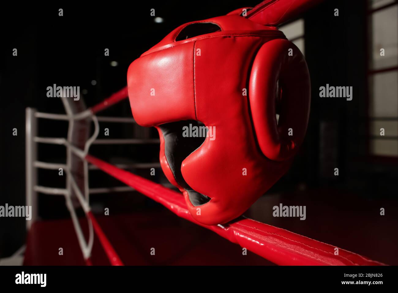 Headgear on ropes of boxing ring in gym Stock Photo - Alamy