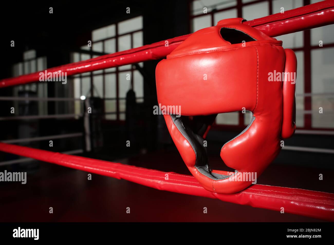 Headgear on ropes of boxing ring in gym Stock Photo - Alamy