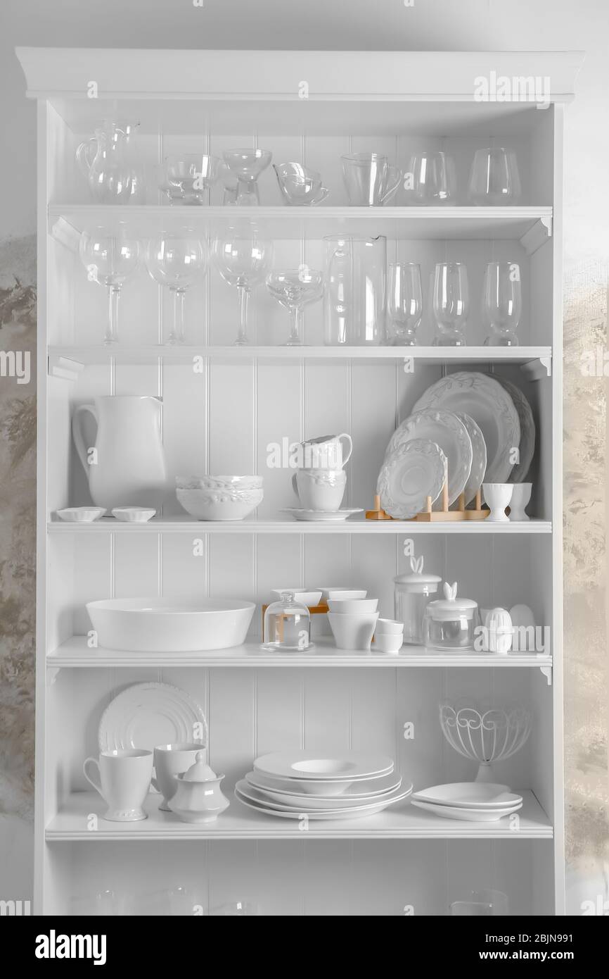 Storage stand with glassware and tableware indoors Stock Photo - Alamy