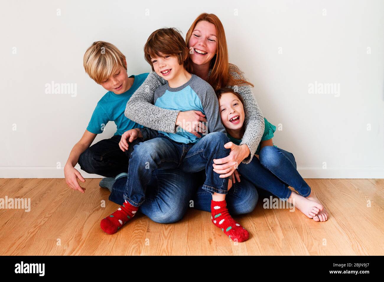 Portrait of a mother with her three children Stock Photo - Alamy