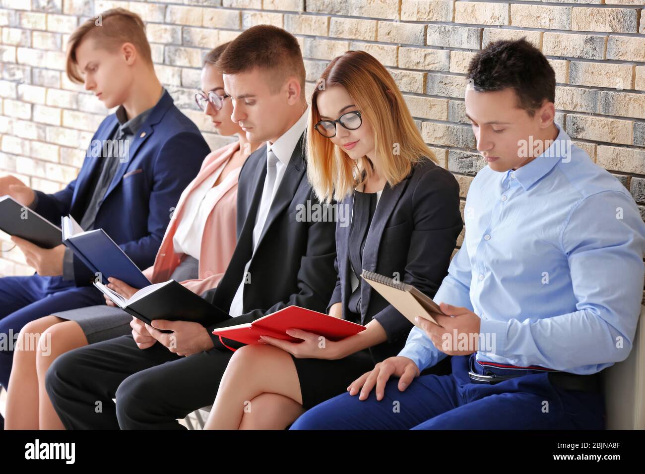 Group of people waiting for job interview on chairs Stock Photo - Alamy