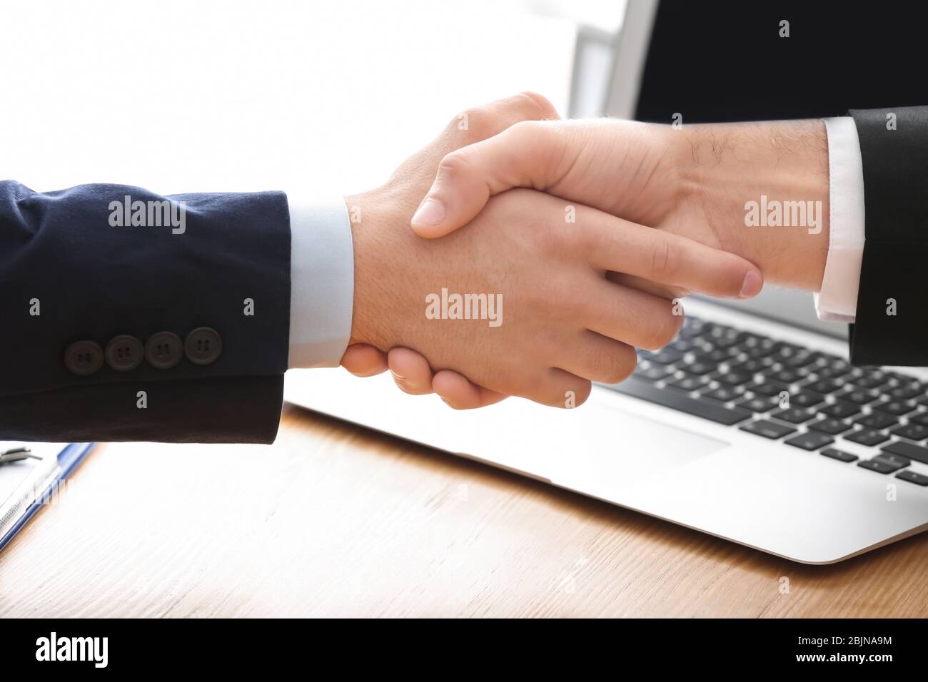 Human resources manager shaking hands with applicant Stock Photo - Alamy