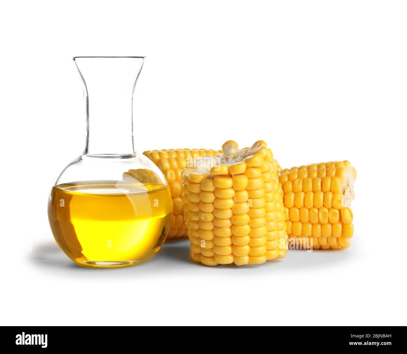 Decanter with corn oil and cut cob on white background Stock Photo - Alamy