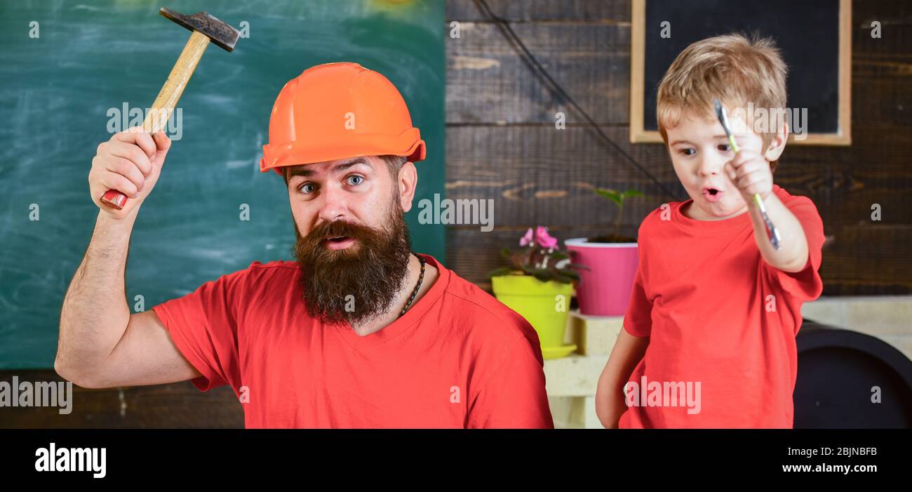 Boy, child cheerful holds spanner wrench, learning use tools with dad ...