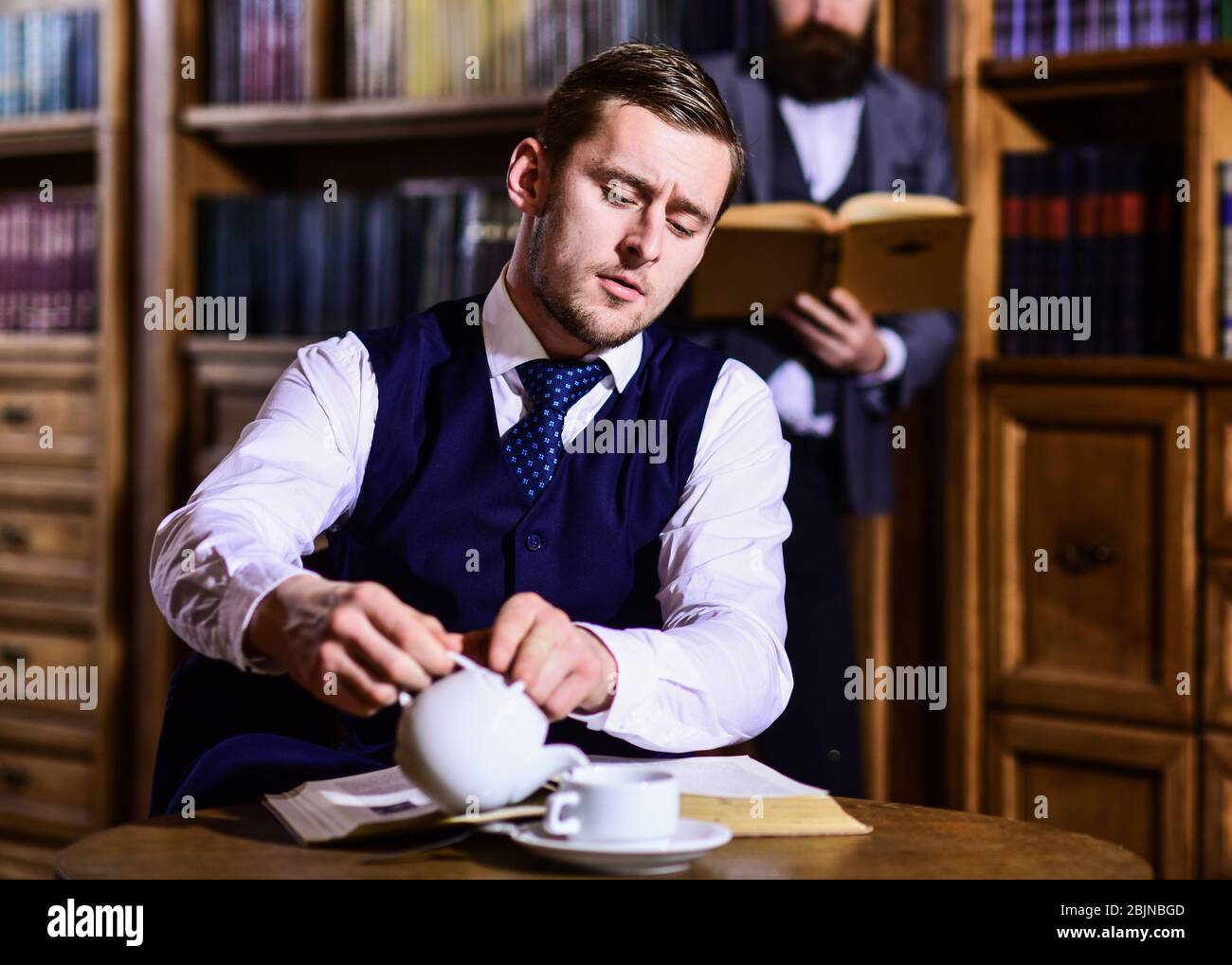 Man with strict face at tea party. Retro detective drinks tea in ...
