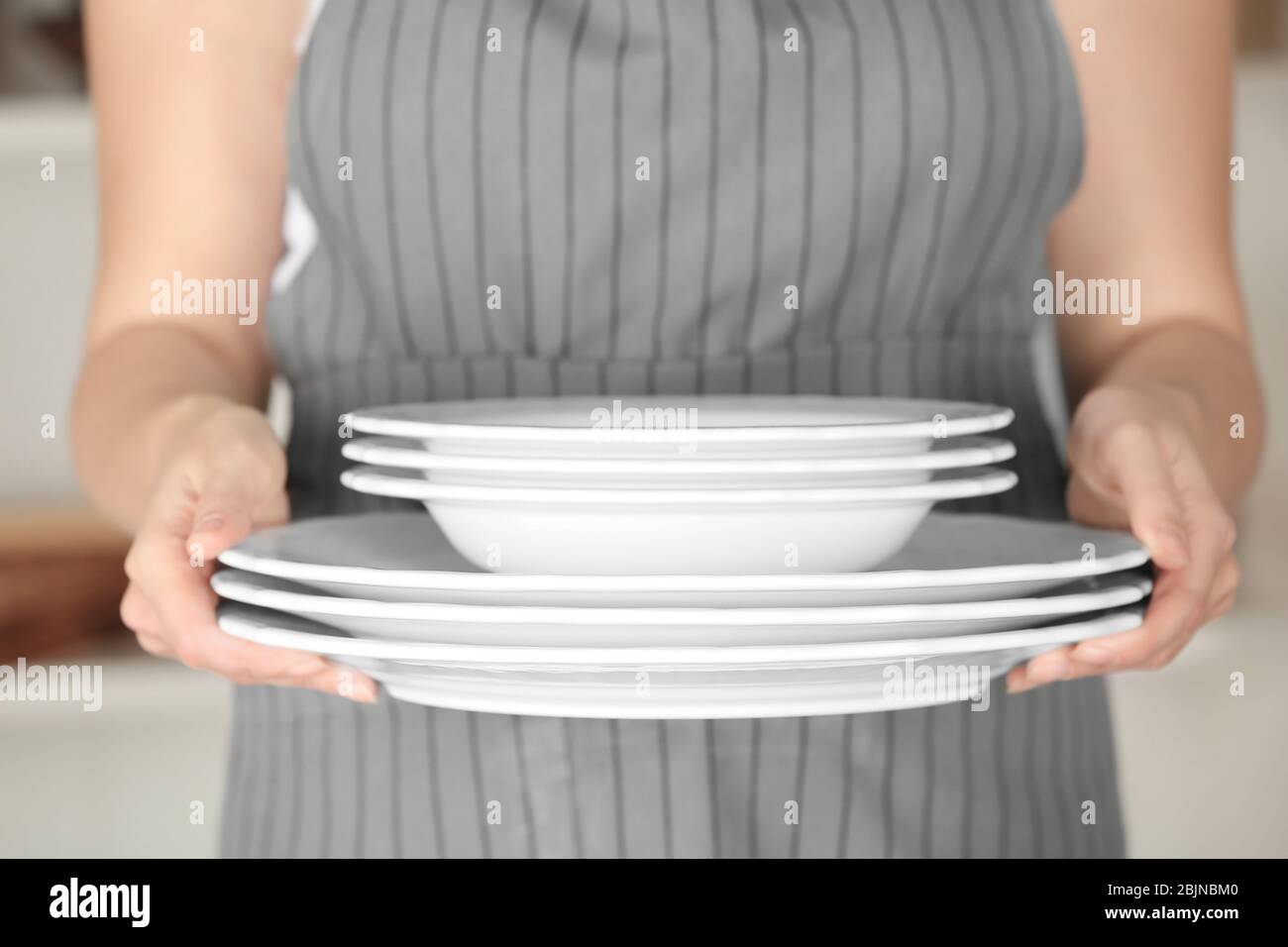 Hands holding stack of plates hi-res stock photography and images - Alamy