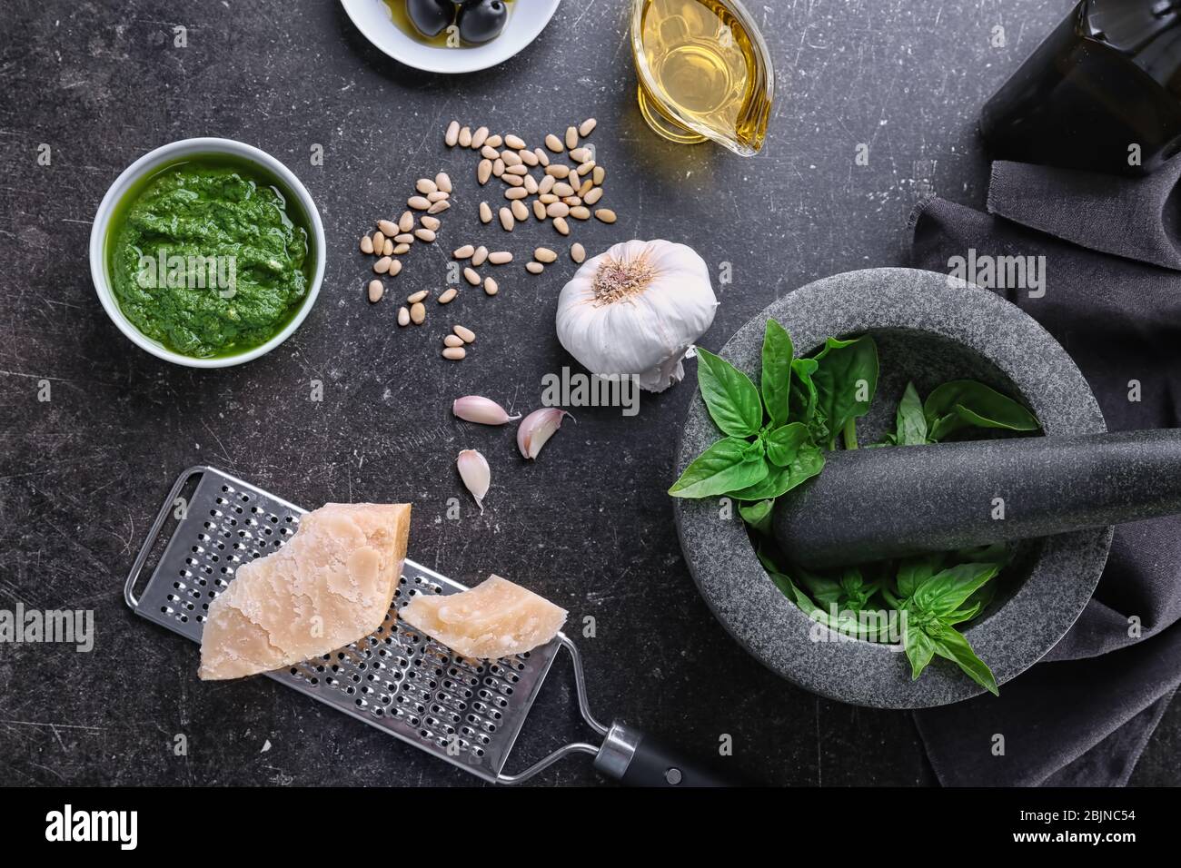 Ingredients for basil pesto sauce on grey background Stock Photo - Alamy