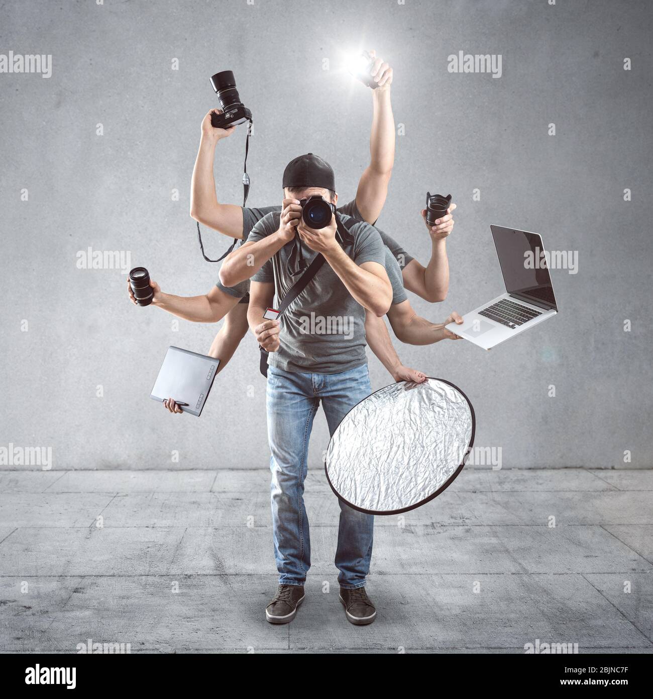Funny photographer with a lot of equipment Stock Photo - Alamy