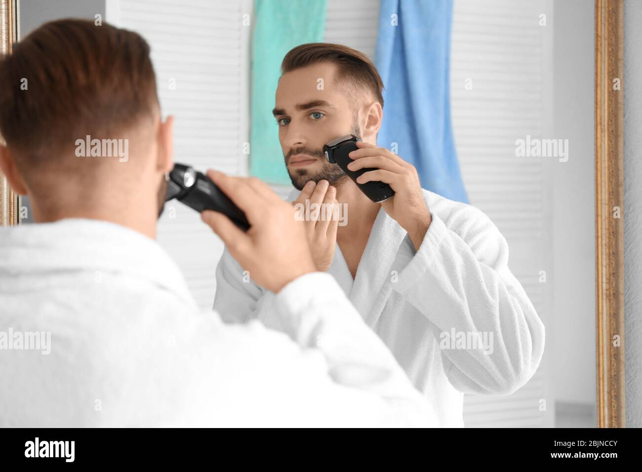 Serious young man shaving hi-res stock photography and images - Alamy