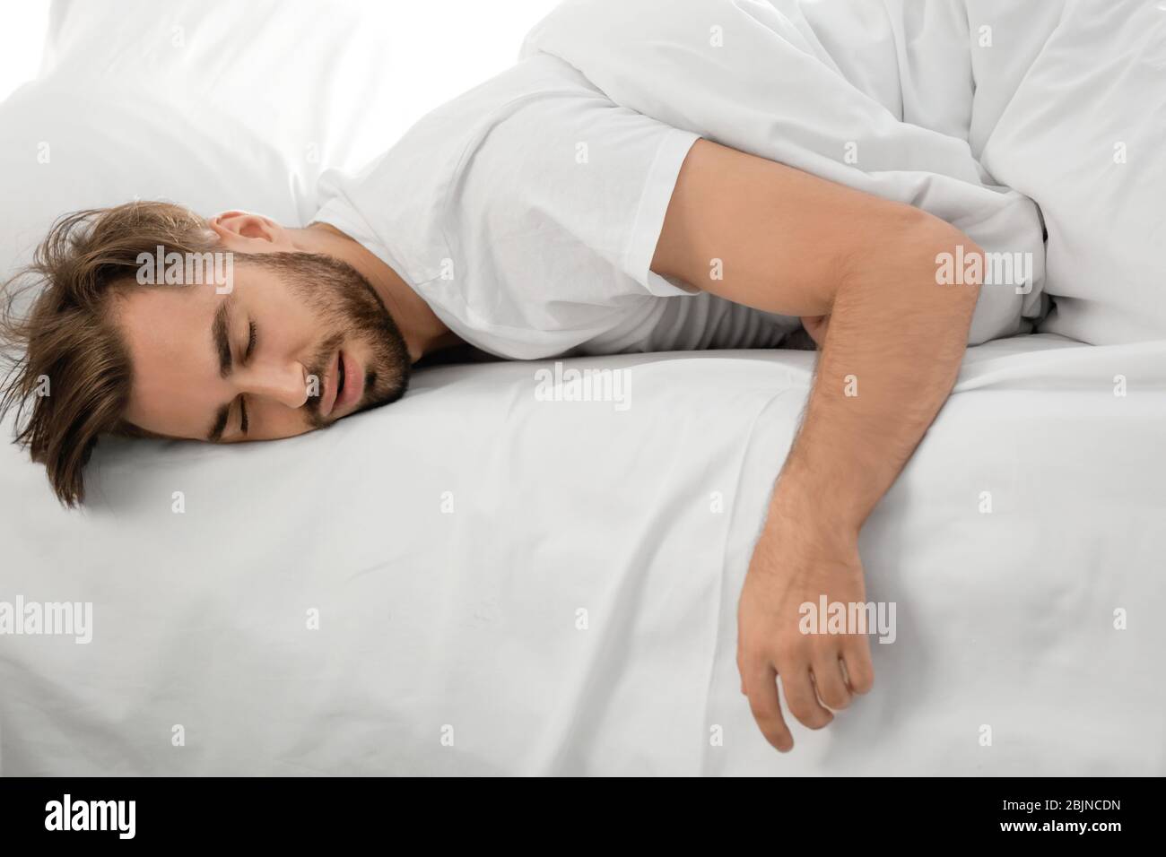 Morning of tired man sleeping in bed at home Stock Photo - Alamy