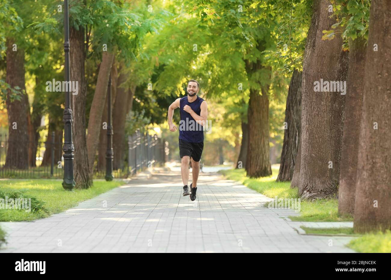 Sporty young man running hi-res stock photography and images - Alamy