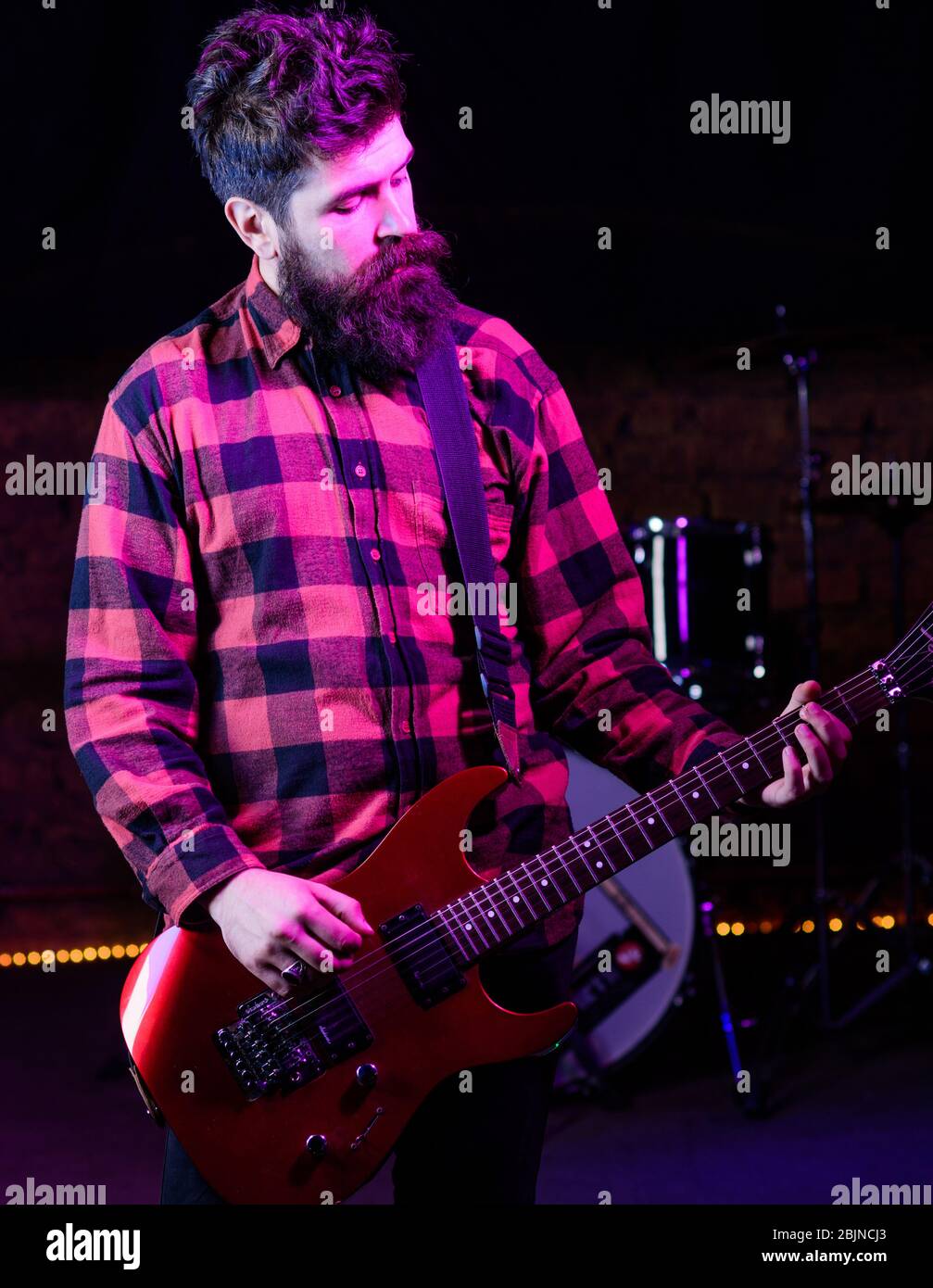 Frontman concept. Man with calm face holds guitar, singing song, play ...